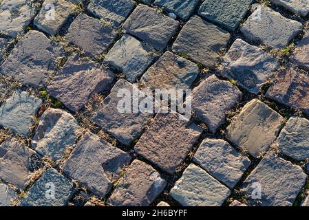 An empty old uneven cobblestone street pavement under sunlight Stock ...