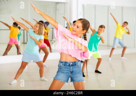 Group of kids training modern dance moves Stock Photo - Alamy