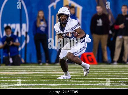 Utah State running back Calvin Tyler Jr. (4) gets past Hawaii defensive ...