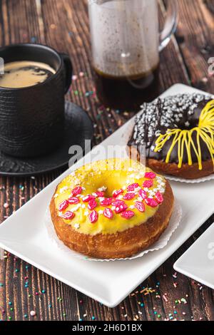 Delicious donuts decorated with different decorations on wooden table ...