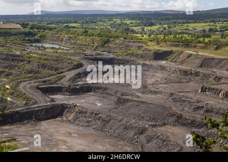 Quarrying of lime stone in a stone pit, using a dump truck and a wheel ...