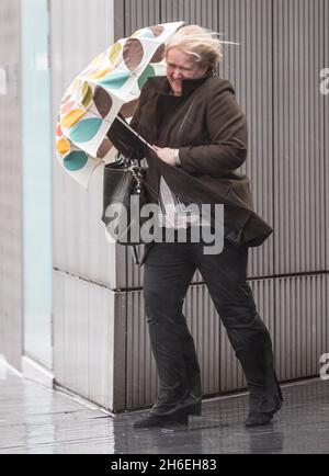 Commuters pictured in the wind and rain in central London this ...