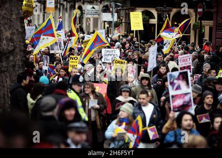 Tibetan protestors are held back by police after the Olympic torch ...
