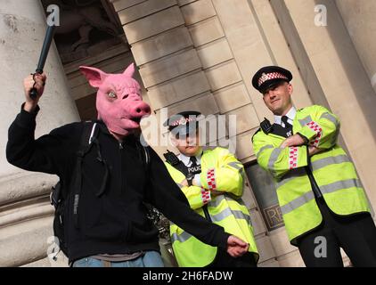 Protestors dressed as pigs and police officers during the traditional ...