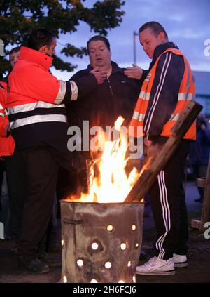 Postal workers and supporters from other unions form a picket line ...