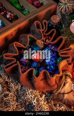 Different colorful role playing dice on table with blurry storage ...