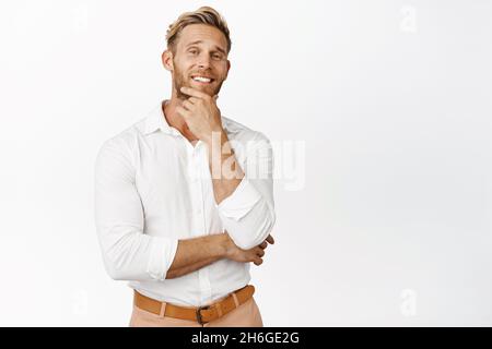 Handsome pleased businessman, rub hands and smiling devious, having ...