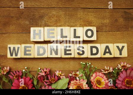 Hello Wednesday alphabet letters with flower frame on purple background ...