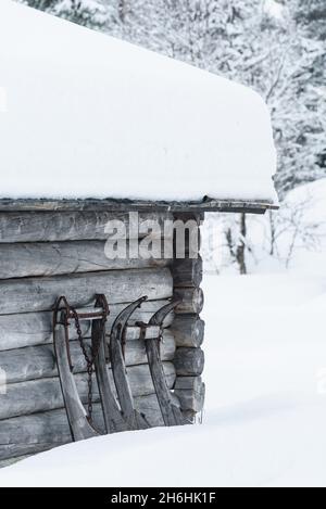 Old sled slides standing against wooden wall Stock Photo - Alamy