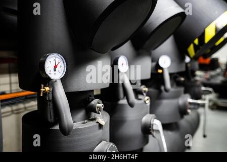 Barometers on pressure pipes, technical room with heat and water ...