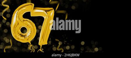 Gold foil balloon number number 67 on a background of black tinsel ...