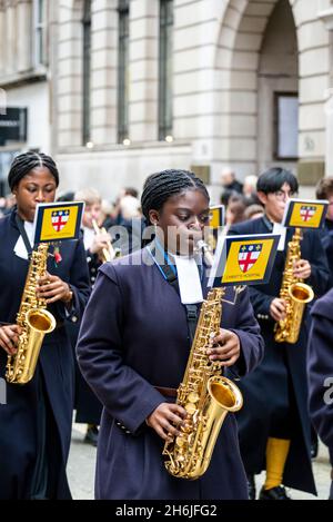 A marching band parade past The Women of World War II Memorial Cenotaph ...