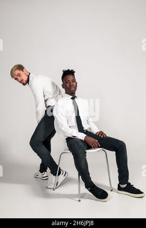 Two stylish men posing and having fun on white background Stock Photo ...