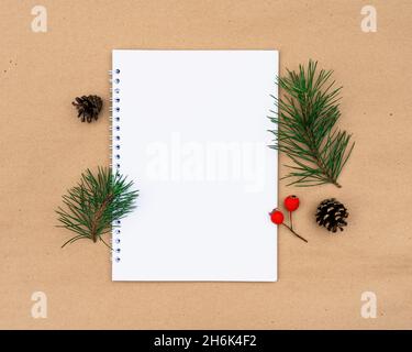 Evergreen sprigs of pine needles, a notebook with an envelope, cones ...