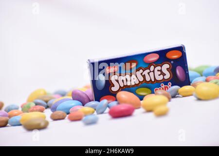 A box of colorful Smarties surrounded by candy, manufactured by Nestlé ...