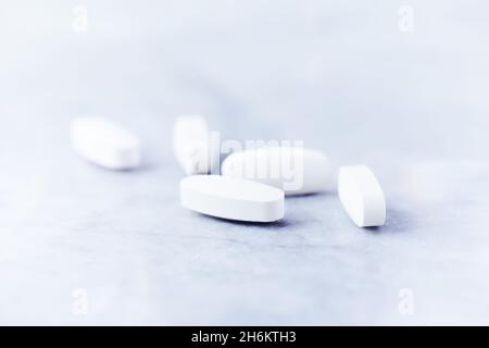 Beta - Alanine tablets. A dietary supplement on bright stone background ...