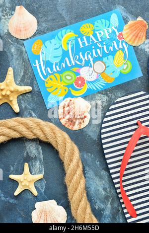 Flip flops, rope, seashells and paper card with text HAPPY THANKSGIVING ...