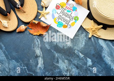 Flip flops, seashells, dry leaves and paper card with text HAPPY ...