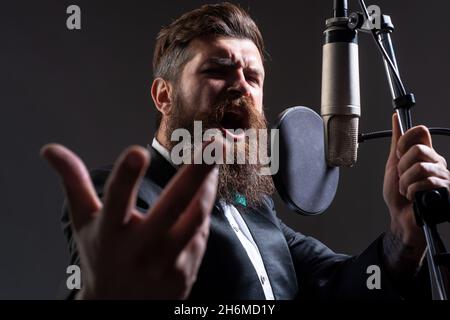 Classic singer in suit. Man singing with music microphone Stock Photo ...