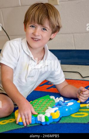 A kindergartner plays with the Phonics Firefly electronic toy by ...