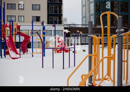Play structures at a snow-covered playground in a residential area of ...