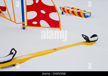 Play structures at a snow-covered playground in a residential area of ...