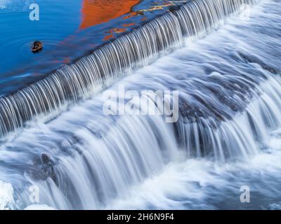 A small flat cascade in a calm river. Water background Stock Photo - Alamy