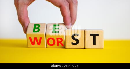 Best or worst symbol. Businessman turns wooden cubes and changes the ...