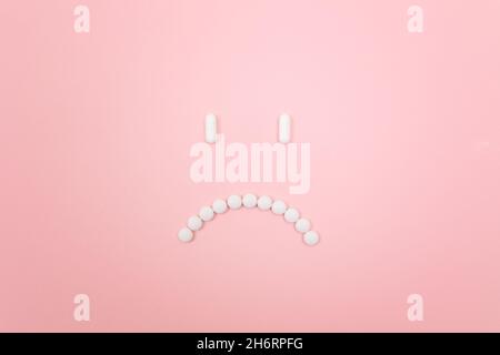 Pharma Harm. Sad Smiley Face Made from White Pills, Lying on Pink ...