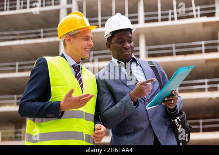 Two engineers discussing project documentation Stock Photo - Alamy