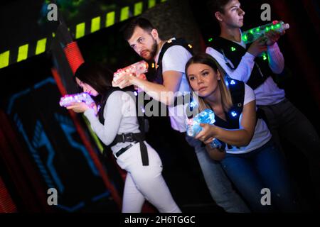 Young people playing laser tag Stock Photo - Alamy