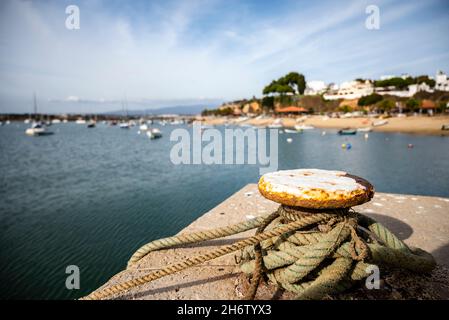 View of fishermen's line harbored in the port of Alvor with cityscape ...
