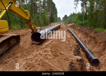 Excavator during earthwork for laying Crude oil and Natural gas ...