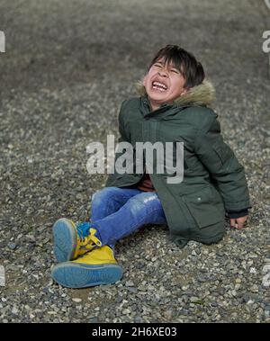 Vertical portrait of sad, crying little kid, boy with close eye. Bad ...