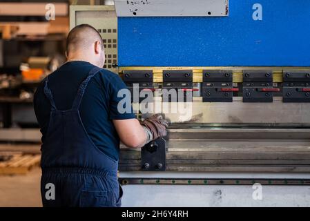 Workers work on sheet metal bending machines Stock Photo - Alamy