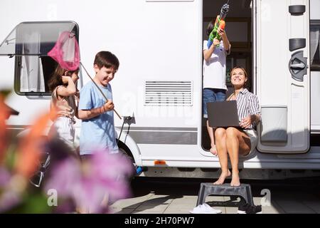Children playing around caravan Stock Photo - Alamy