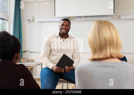 Teacher giving lecture in classroom Stock Photo - Alamy
