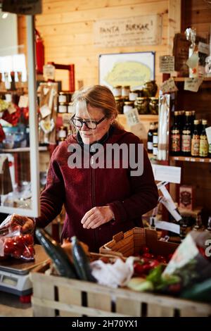 Shop assistant in an organic grocery store and health food shop Stock ...