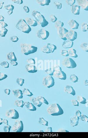 Close up crushed ice in sunlight on blue. Summer background refreshment ...