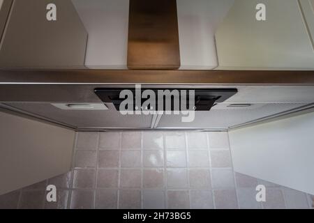 Stainless steel extractor fan above pan on hob in modern kitchen Stock ...
