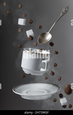 Coffee cup with smoke falling coffee beans on white background Stock ...
