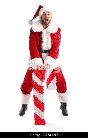 Jumping Santa Claus with candy cane pinata on green background Stock ...