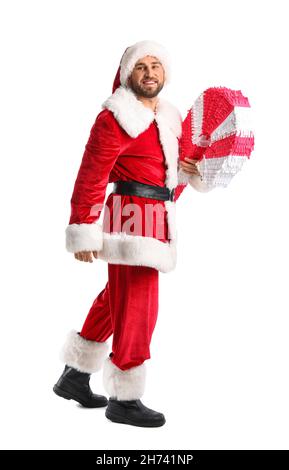 Santa Claus with candy cane pinata showing thumb-up on green background ...
