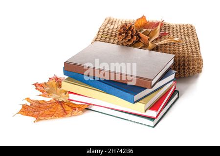 Stack of different books, knitted sweater and autumn decor on white ...