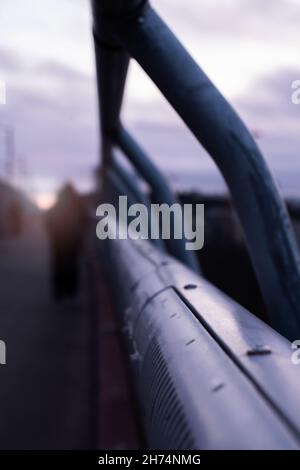 Silhouette walking on the steel footbridge of Murinsel, the peculiar ...