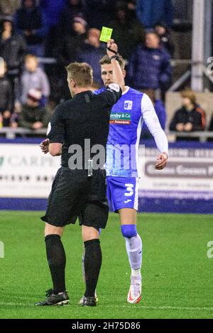 Referee Samuel Barrott shows a yellow card to Bayern's Hiroki Ito ...