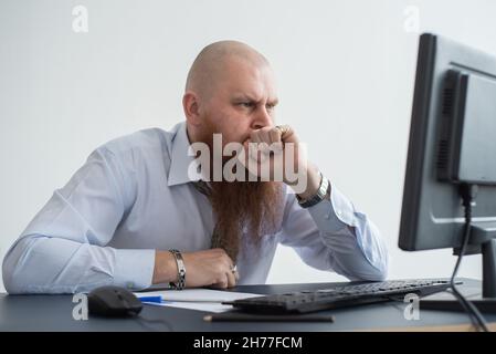 Problems for the office worker. A bald man in a white shirt sits at a ...