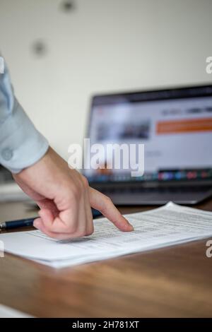 a man checks documents with his finger Stock Photo - Alamy