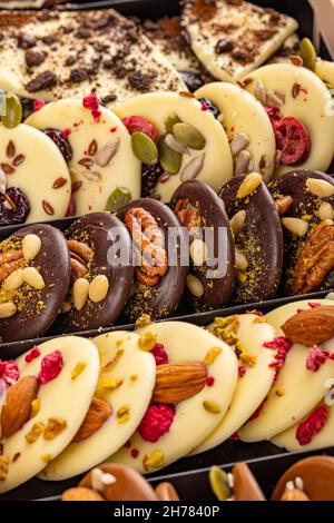 Set of round chocolate candies with nuts on a white background, close ...