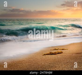 A long exposure of sea waves hitting the rocks Stock Photo - Alamy